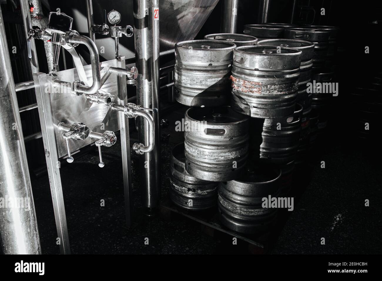 Steel industrial stack of beer kegs against. Modern brewery and ...