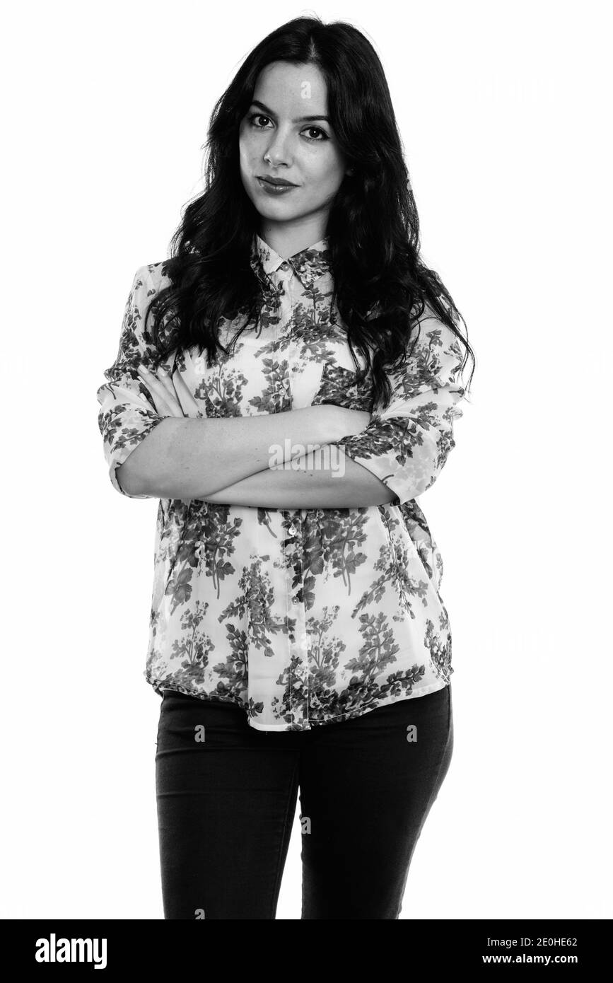 Studio shot of young beautiful Spanish woman with arms crossed Stock ...