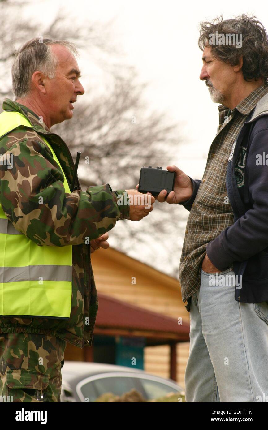 Journalist interviewing a subject with the help of a cassette voice ...