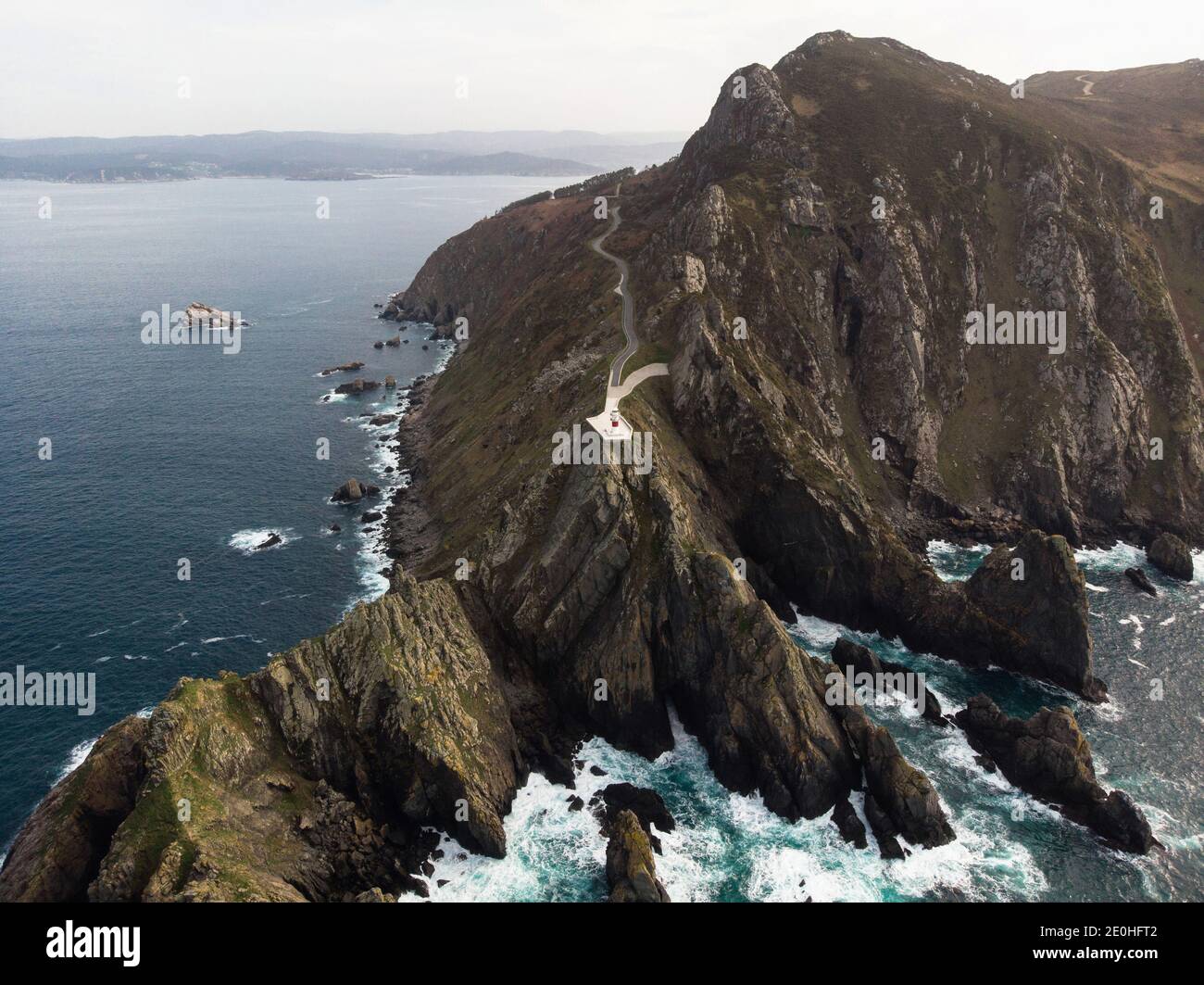 Aerial panorama of Cabo Ortegal lighthouse on steep rocky cliff ...