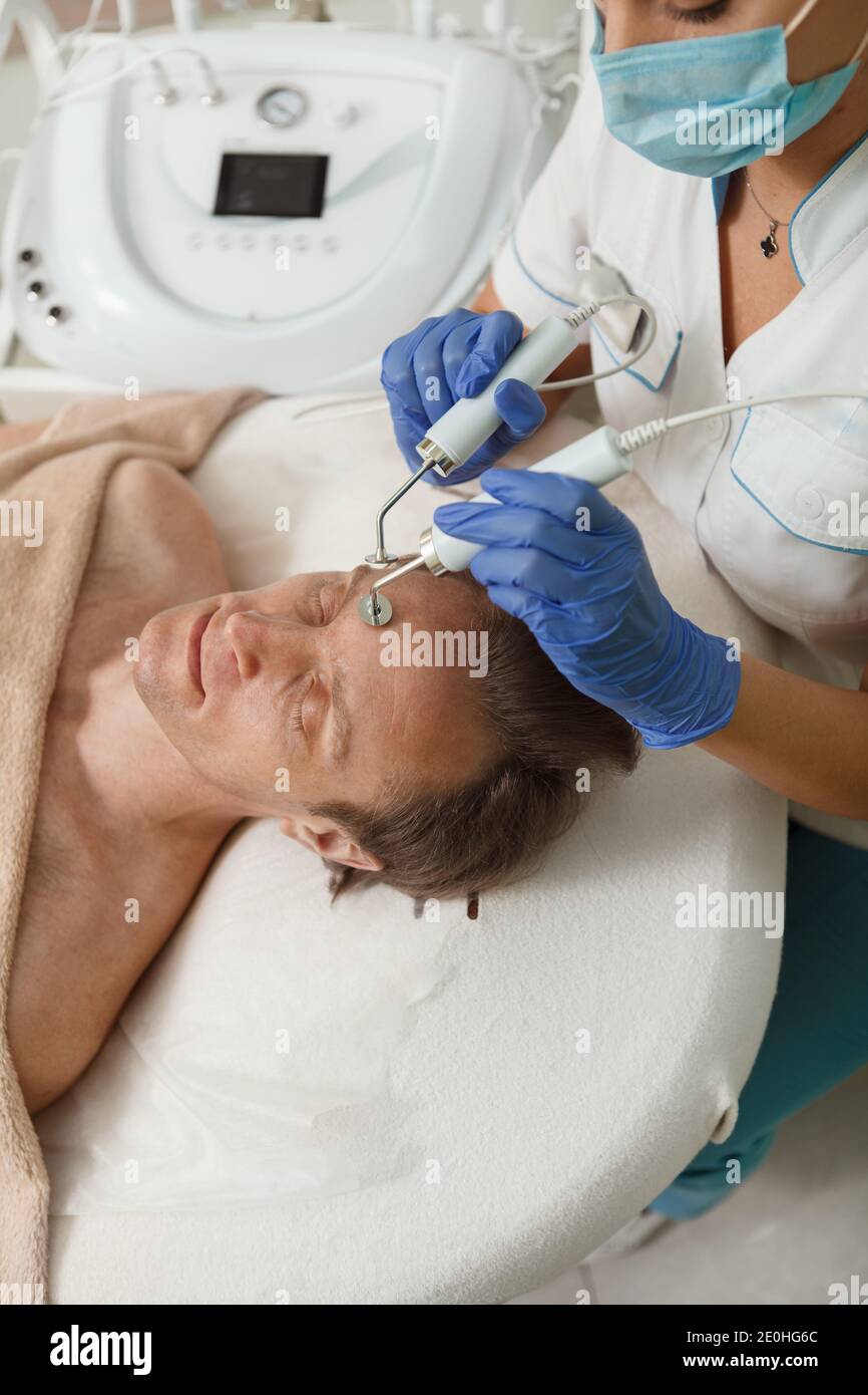 Vertical cropped shot of a professional dermatologist wearing medical ...