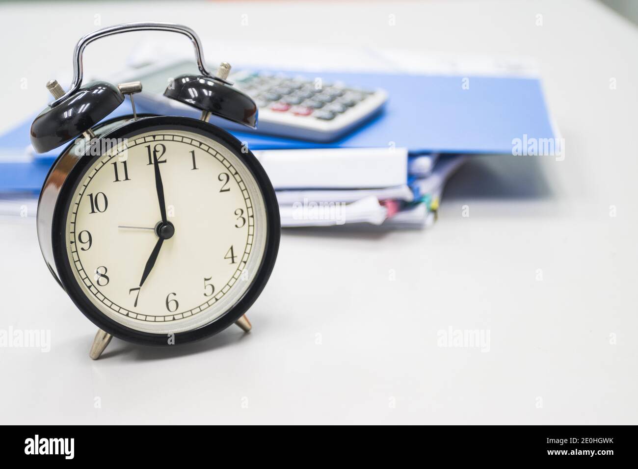 7 AM Clock on work desk in the office Time of businessman working ...