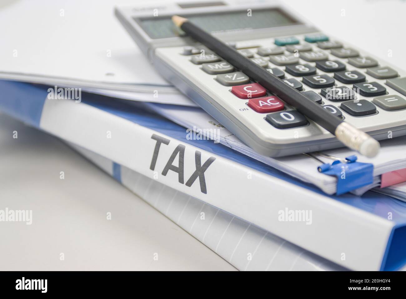 Folder Tax documents and paper files with calculator concept Annual tax ...
