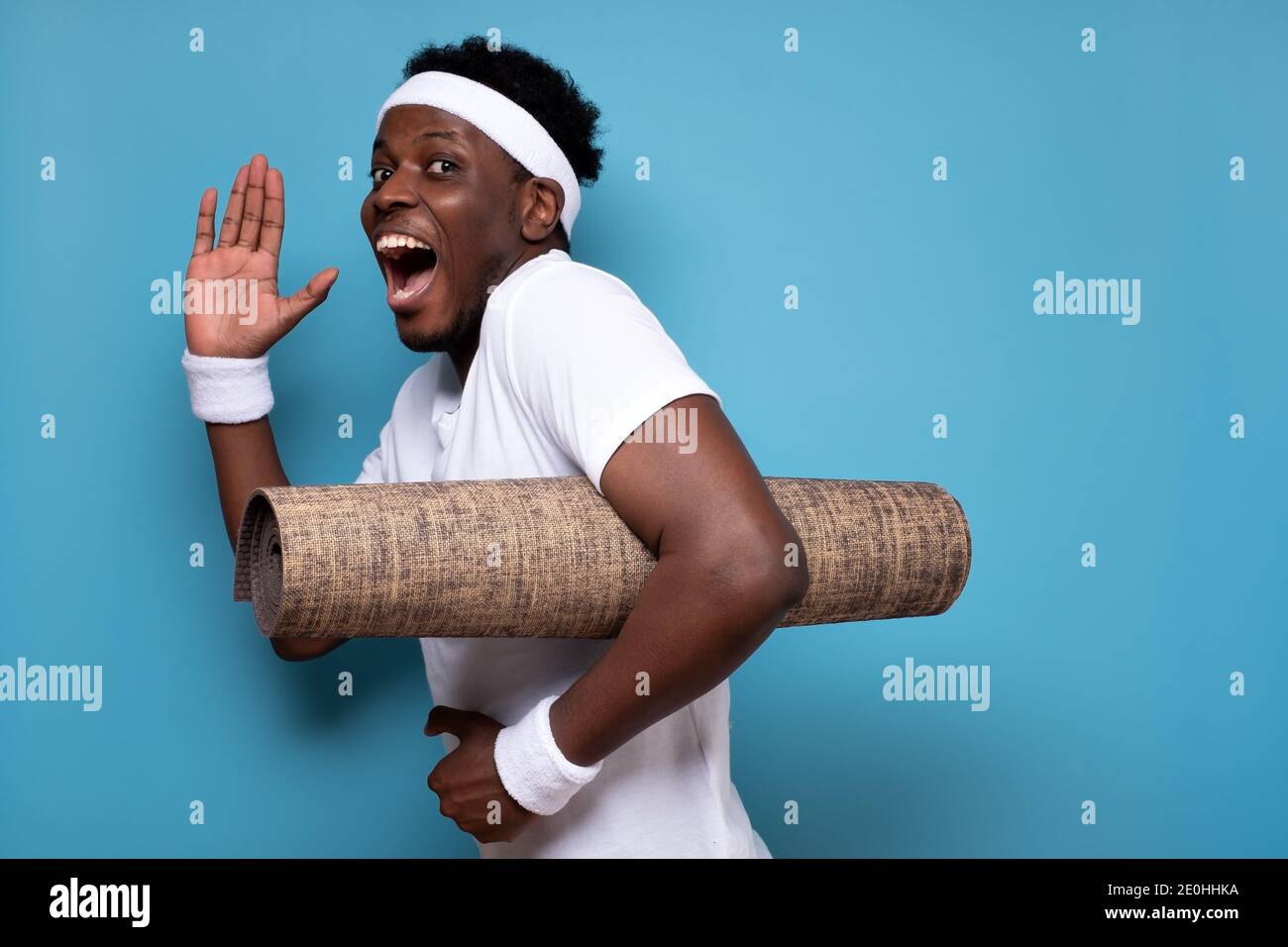 Positive young African american athlete running being late for yoga ...