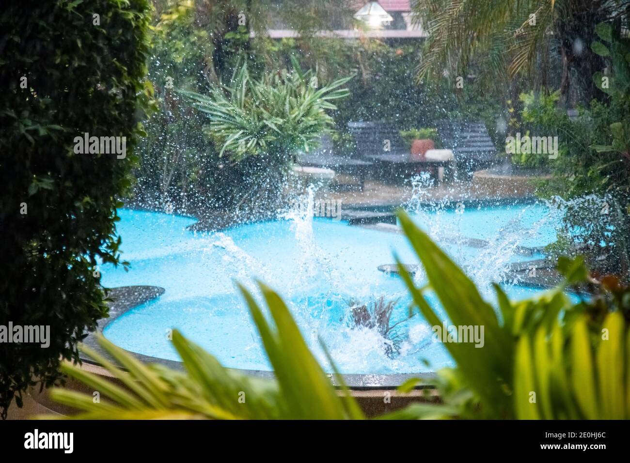 splash of water after jumping into a tropical outdoor pool in the ...