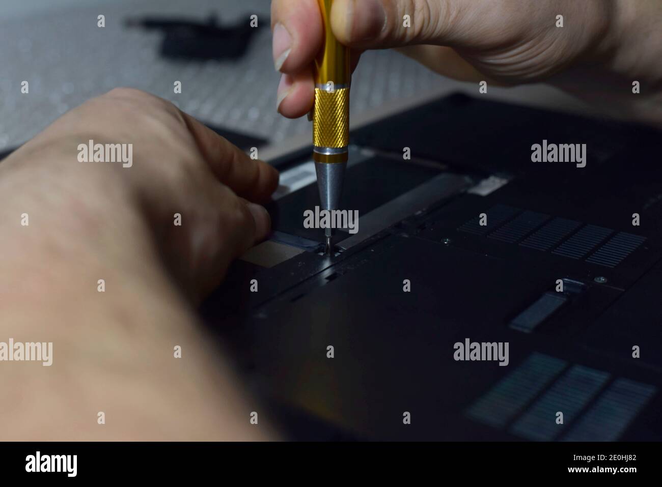 man replacing hard drive on laptop Stock Photo - Alamy