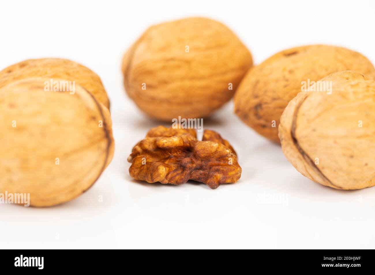shelled walnuts and walnuts in shell on white background Stock Photo ...