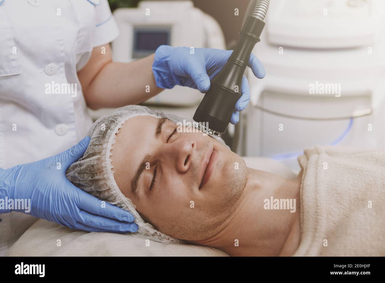 Handsome mature man enjoying microdermabrasion procedure at dermatology ...