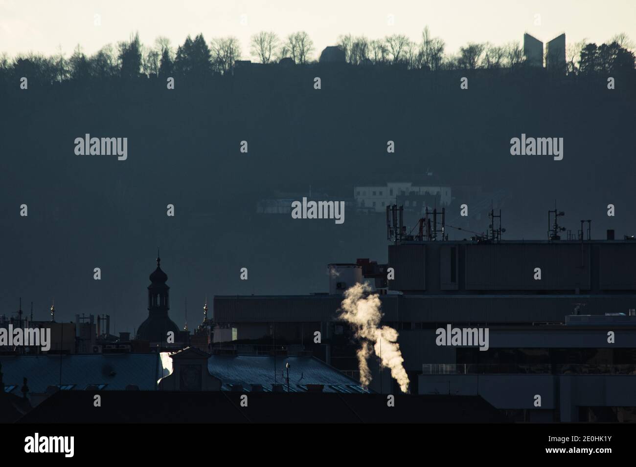 backlit Prague skyline buildings siwh smoke chimneys silhouette Stock ...