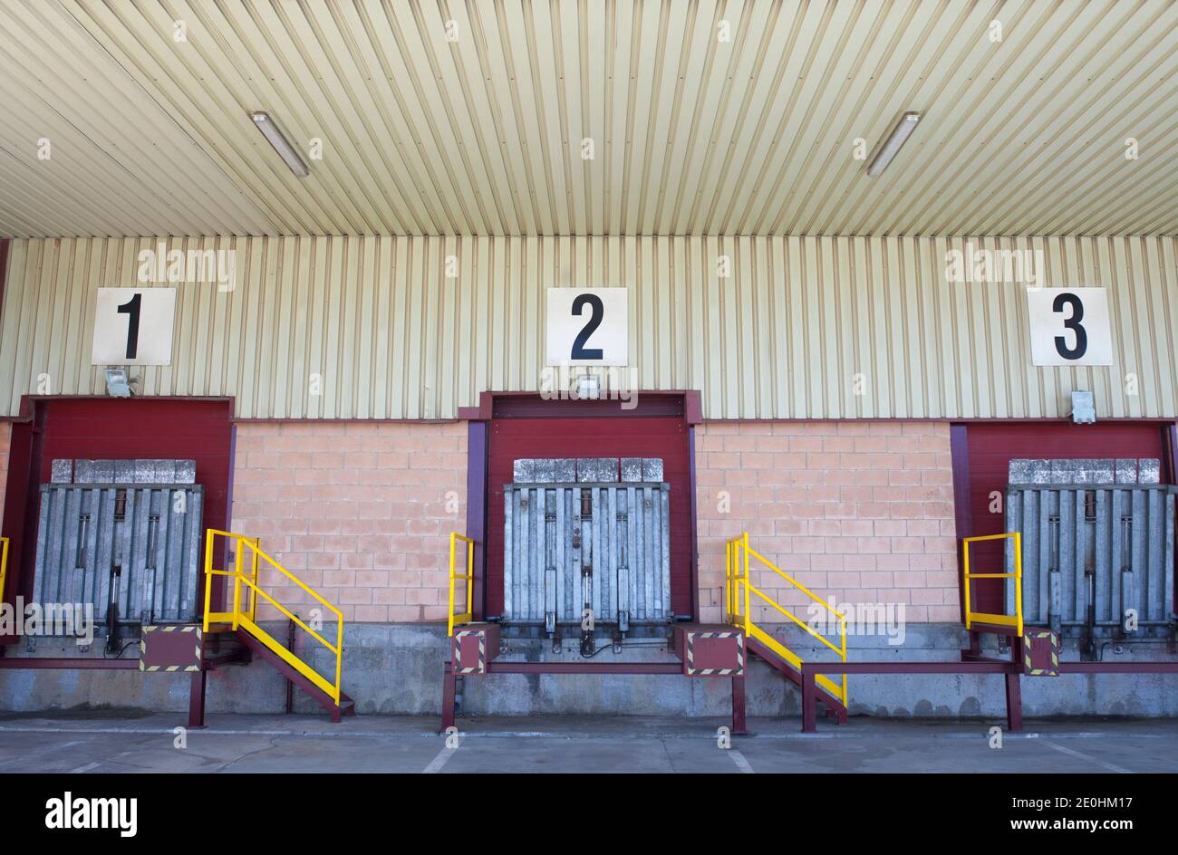 Truck loading docks at commercial building. Overhead door, dock leveler ...