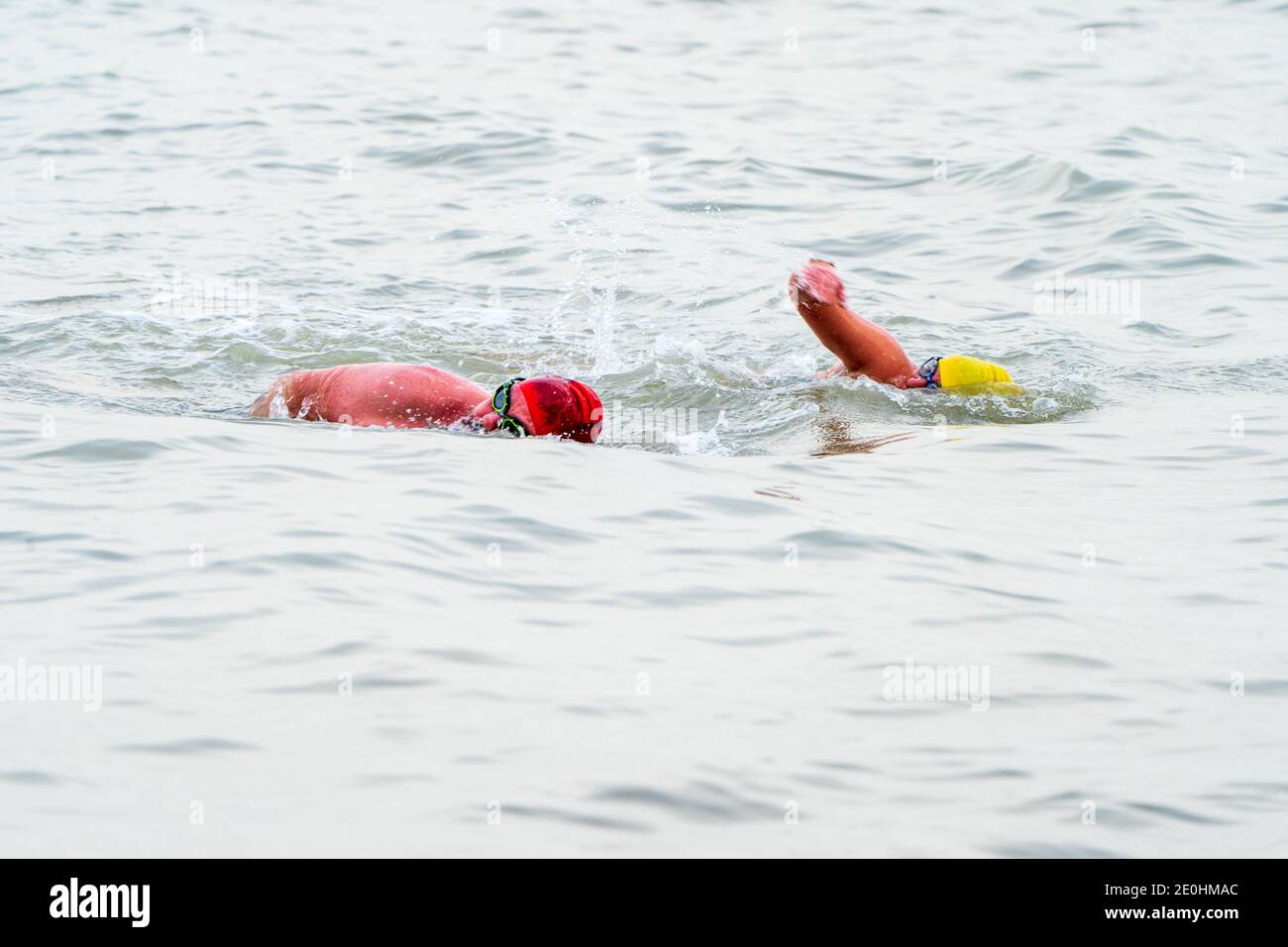 Two people swimming in the freezing cold sea on New Year's day during ...