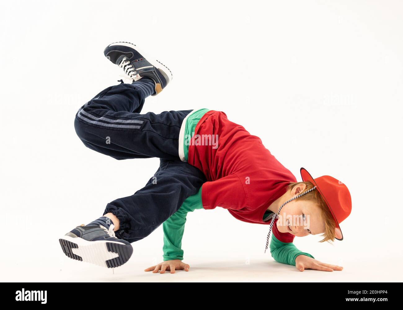 a boy with red hair in a cap in a breakdance pose Stock Photo - Alamy