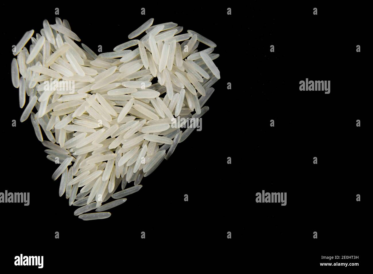 heart-shaped rice on a black background with a place to sign Stock ...