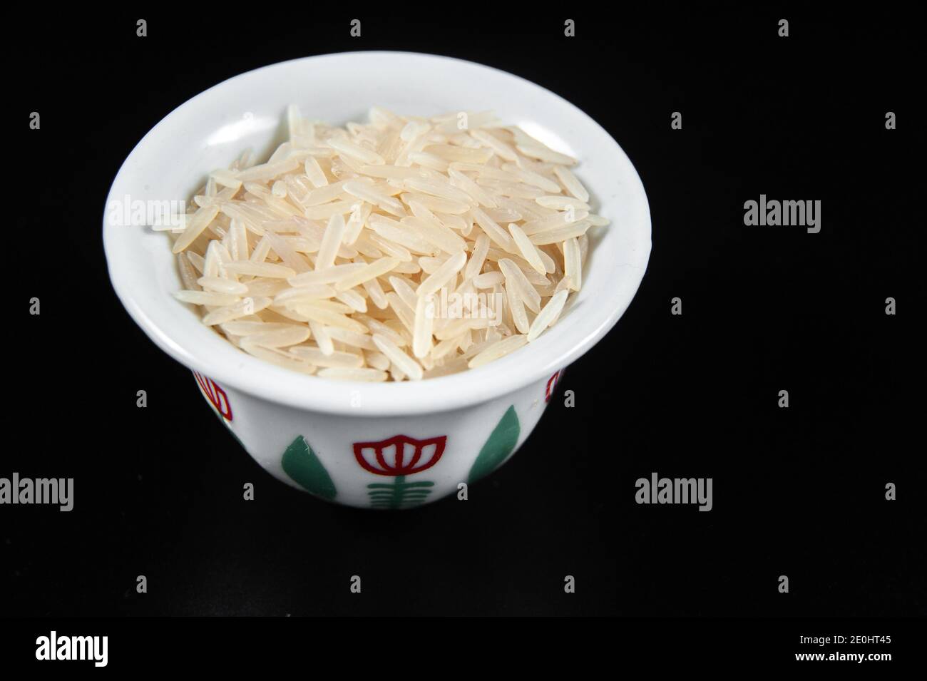 white rice in a plate on a black background, macro photograph Stock ...