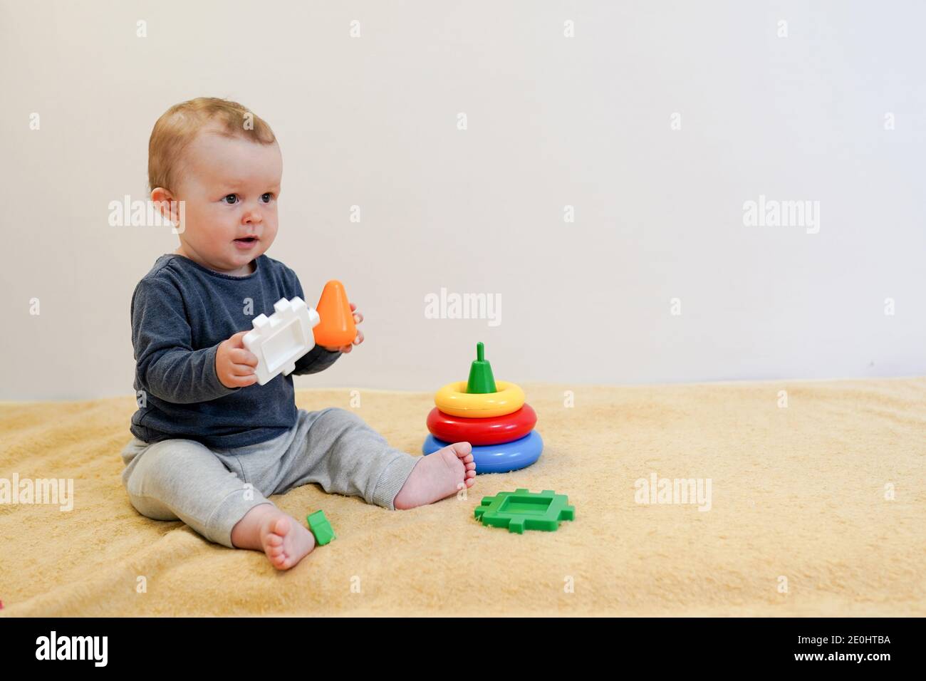 Baby smilling and playing with colorful toys at home. child background ...