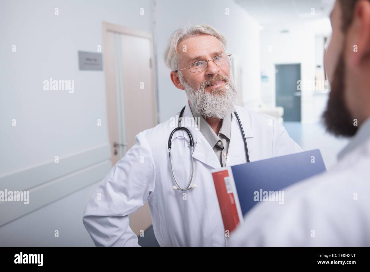 Confident team doctors talking patient hi-res stock photography and ...