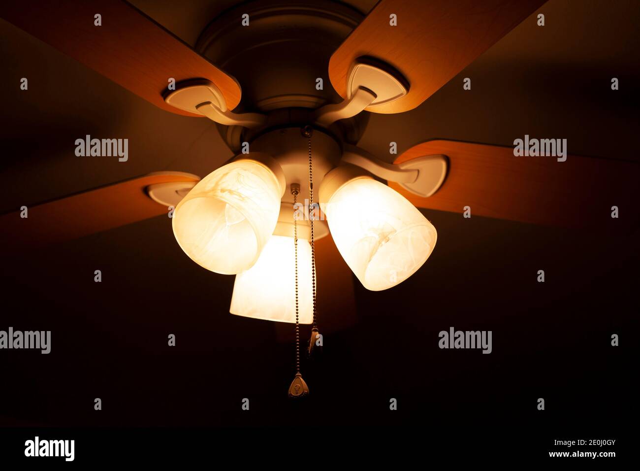 Overhead fan with three bright lights turned on Stock Photo - Alamy
