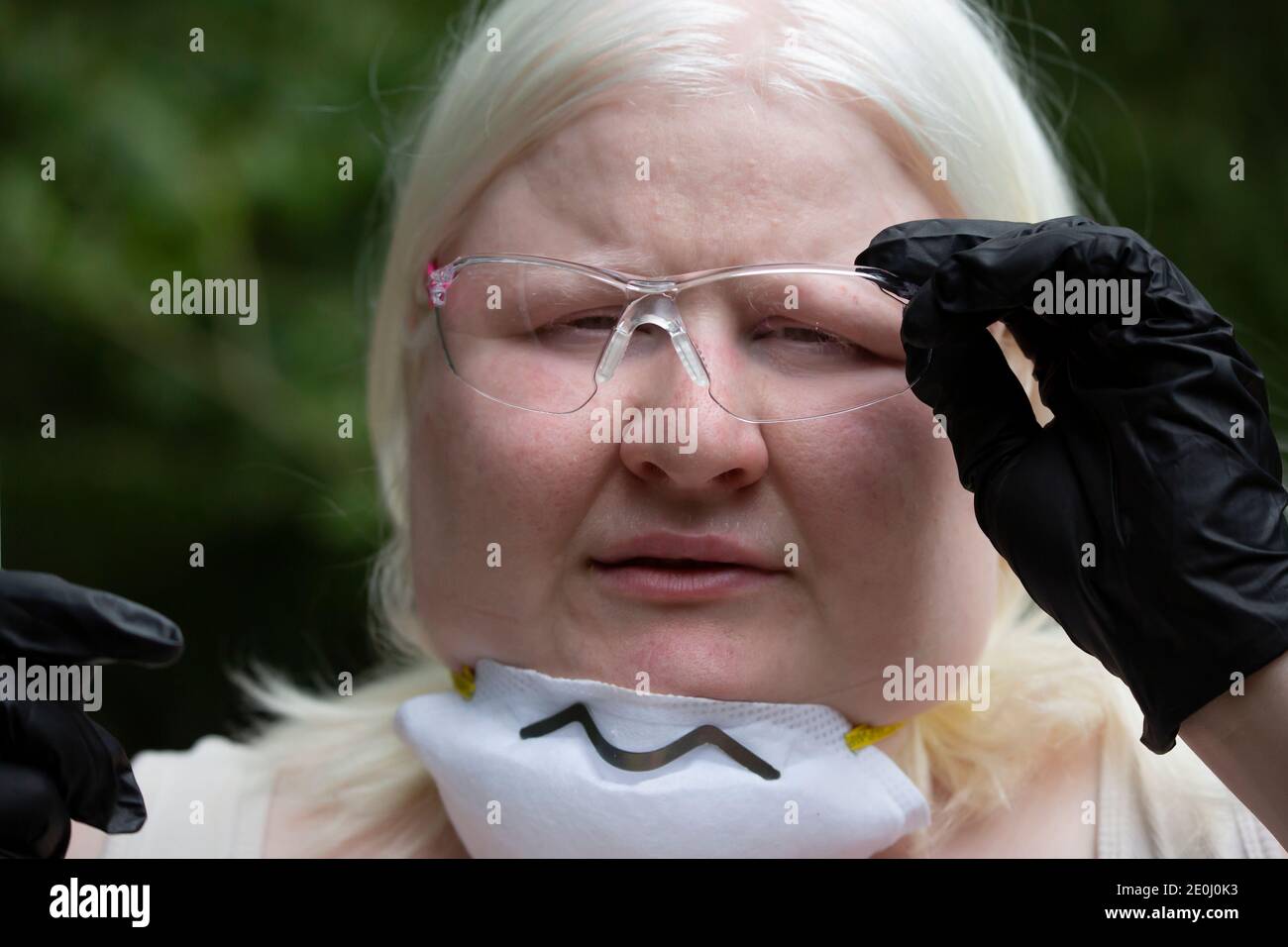 Woman putting on safety glasses hi-res stock photography and images - Alamy