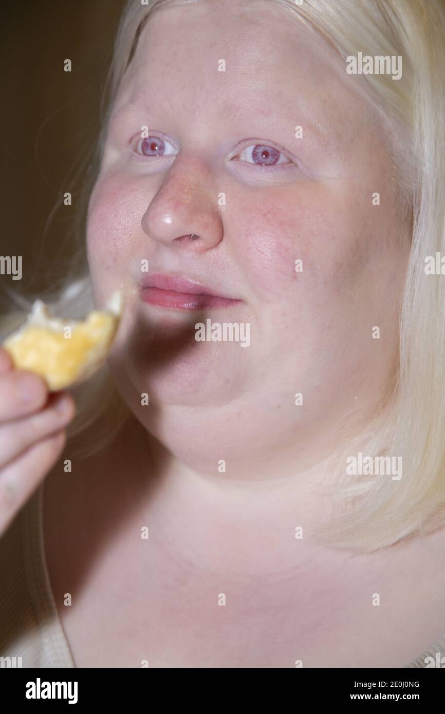 Woman who is full still eating a buttermilk biscuit Stock Photo - Alamy