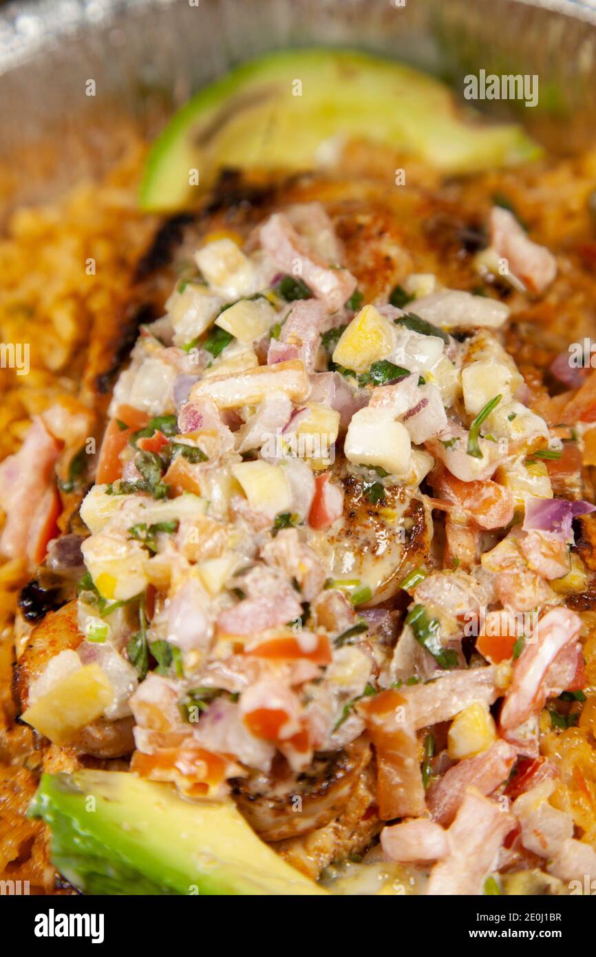 Baked chicken and shrimp over rice, smothered in a mango salsa with ...