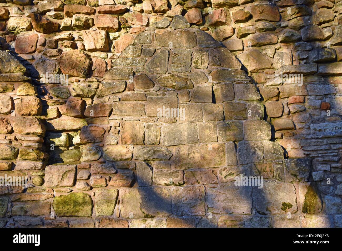 Section of medieval stone wall with arch feature Stock Photo - Alamy