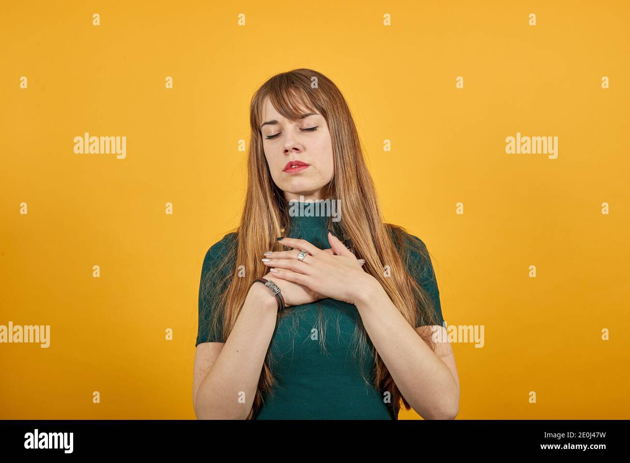 Holding hands near heart, presses arm to chest, expresses gratitude ...