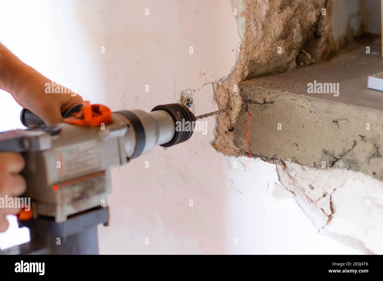 The worker drills with a drill. Renovation and restoration of the old ...