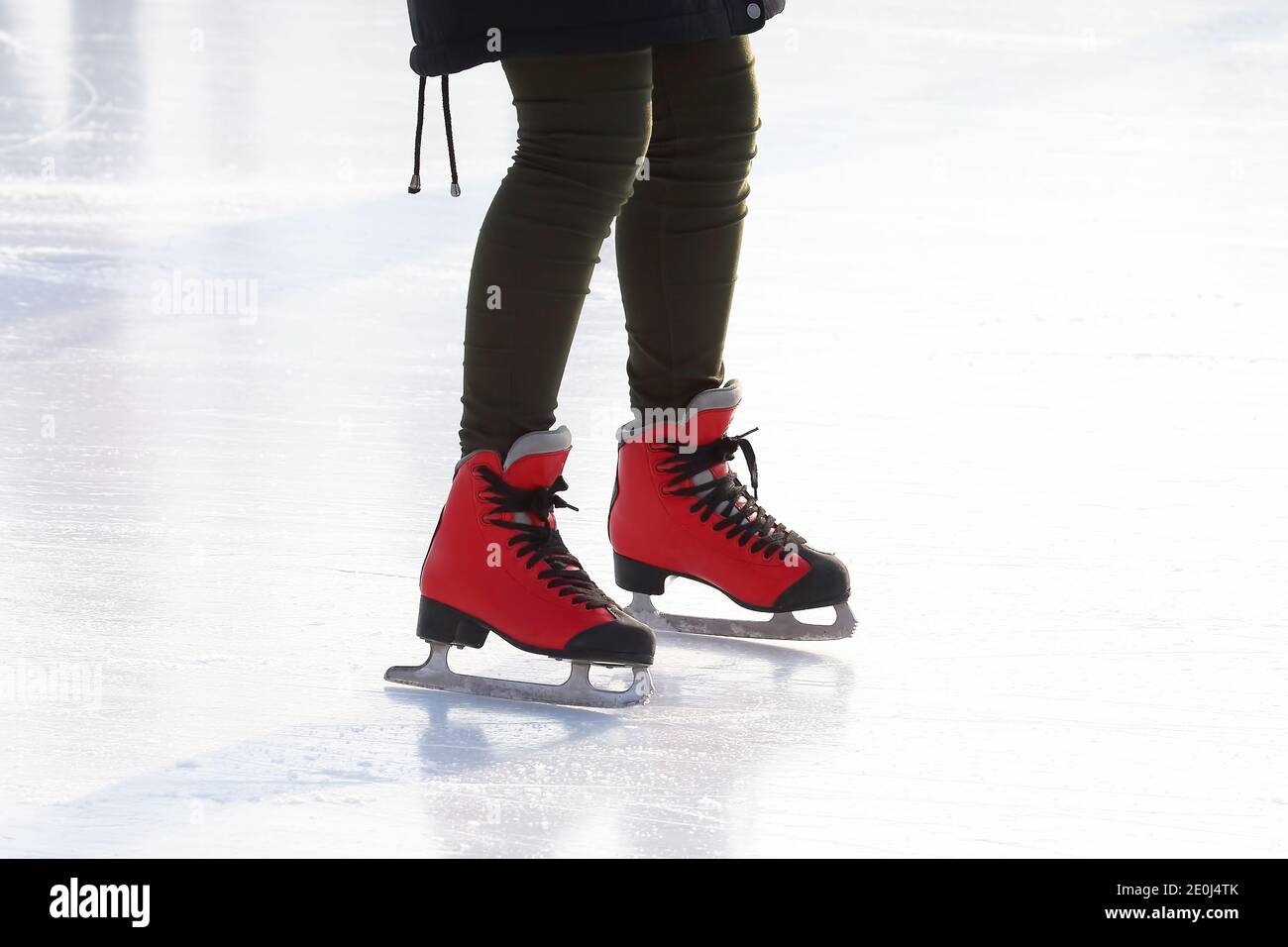 Female legs in skates on an ice rink Stock Photo - Alamy