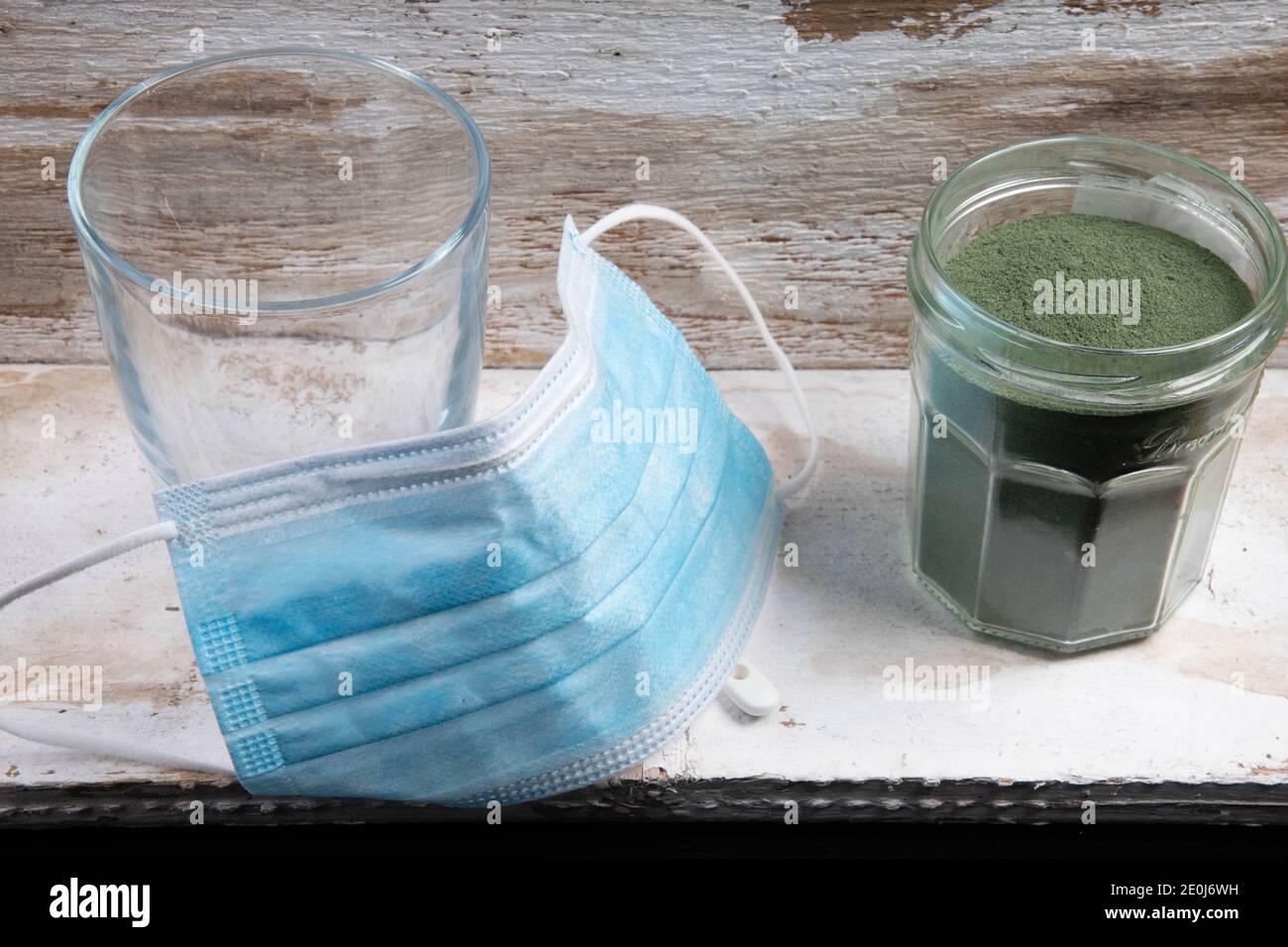 Mouth mask in a jar with green food supplement Stock Photo - Alamy