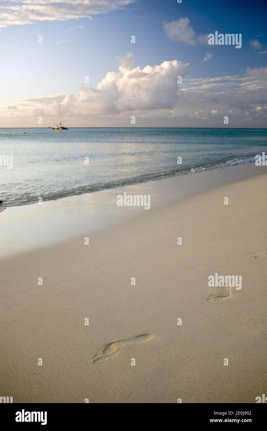 Footprints in the sand at sunset on the High Rise Hotel area beach, on ...