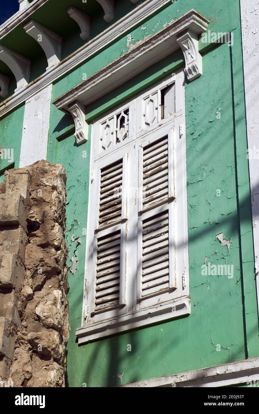 A green and white Dutch colonial building stands in downtown Oranjestad ...