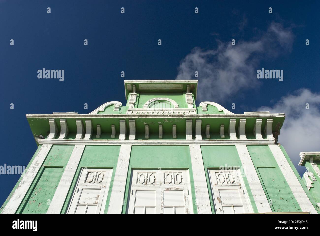 A green and white Dutch colonial building stands in downtown Oranjestad ...