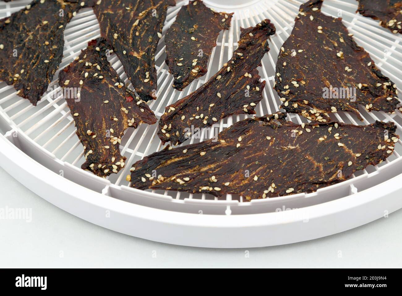 dried beef slices in spices with sesame seeds Stock Photo - Alamy