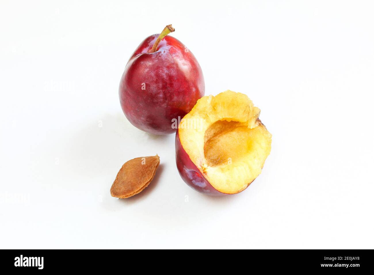 Fresh plum,half plum and seed separated and isolated on white ...