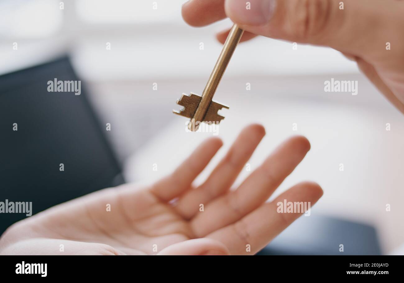 handing the key from hand to hand in the office business finance work ...