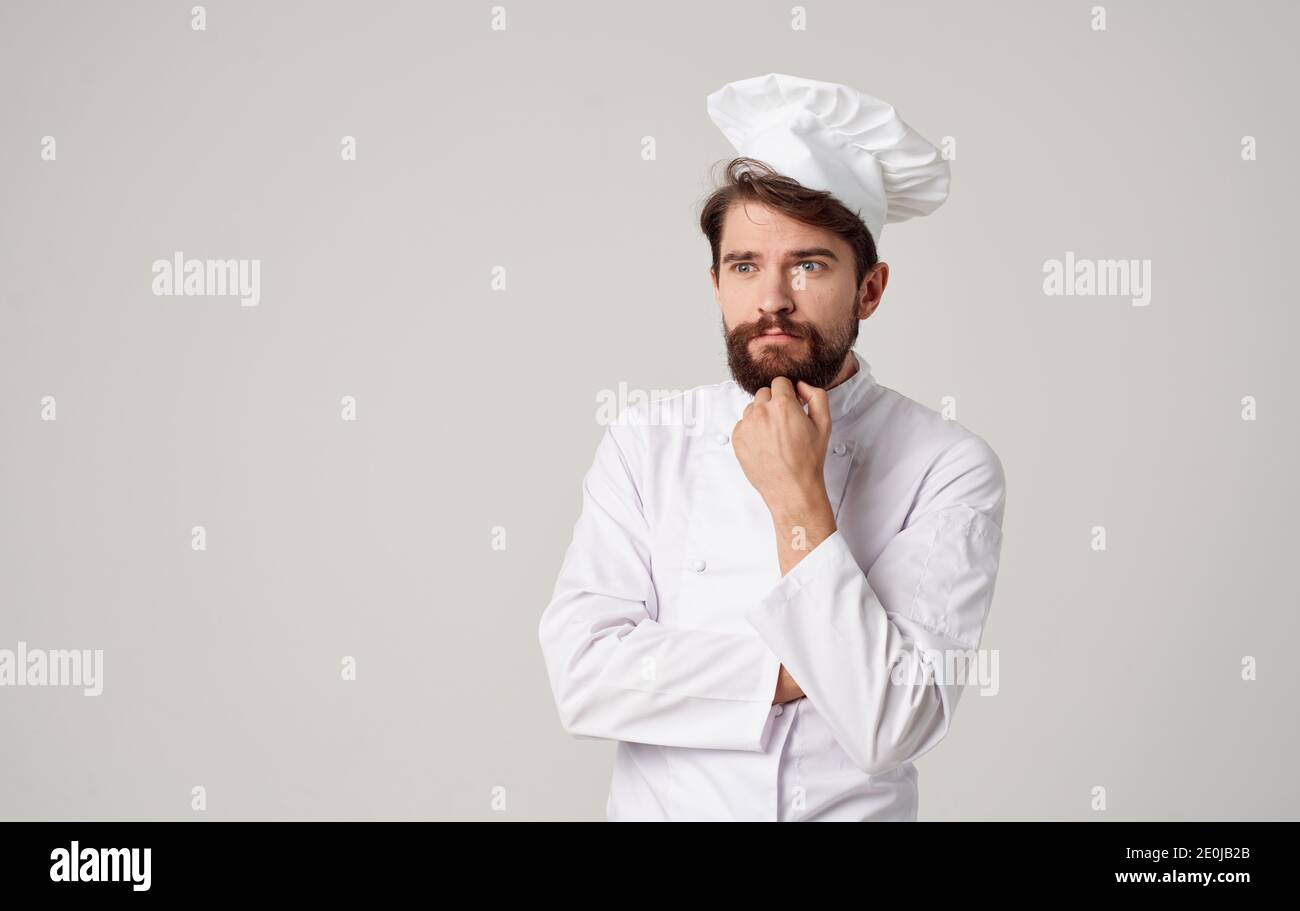 chefs in professional clothes gesturing with hands on a light ...