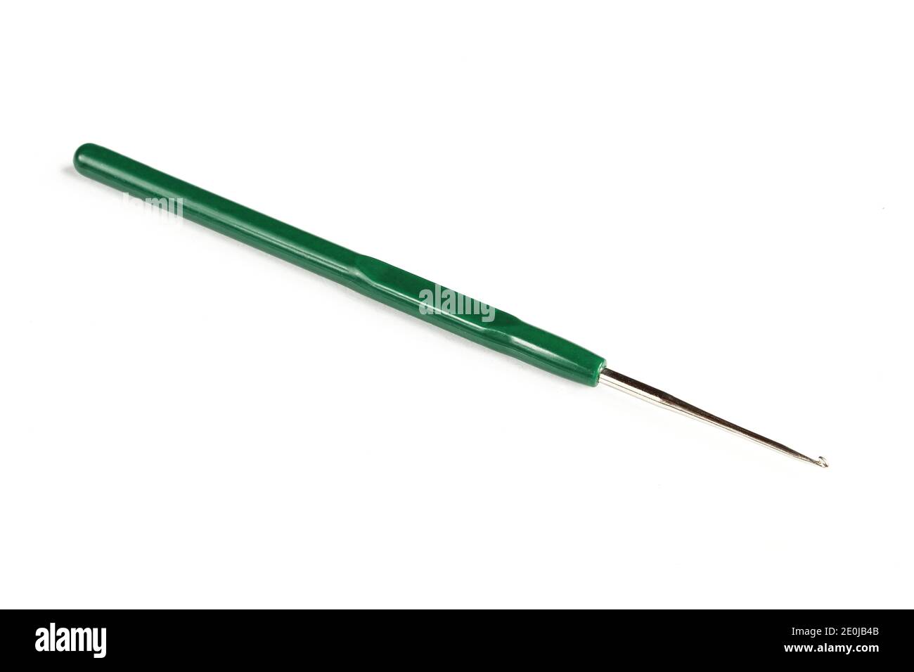 Green handle on metallic crochet hook for knitting isolated on white ...