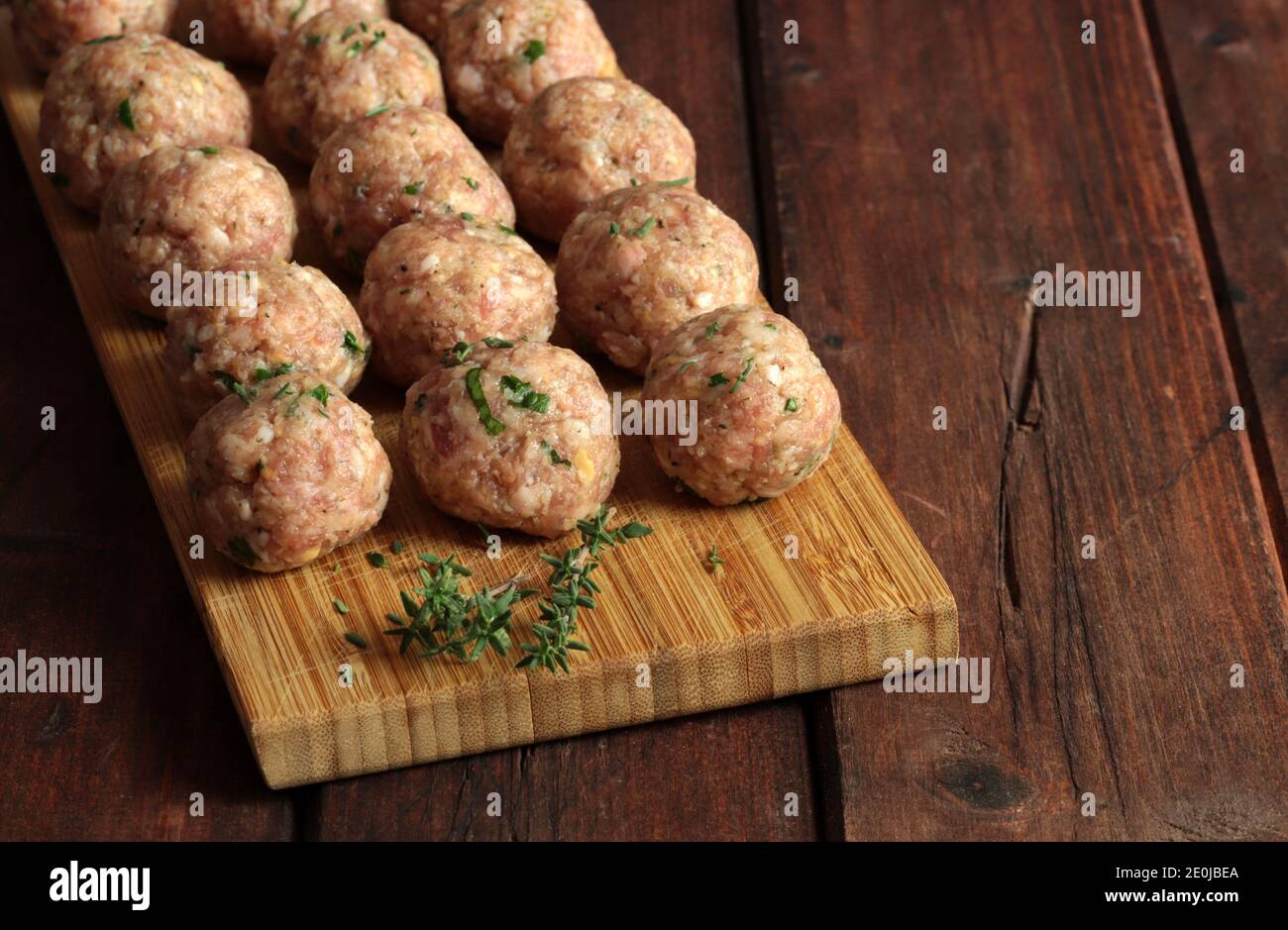 Fresh raw meat balls isolated on wooden table. Copy space Stock Photo ...