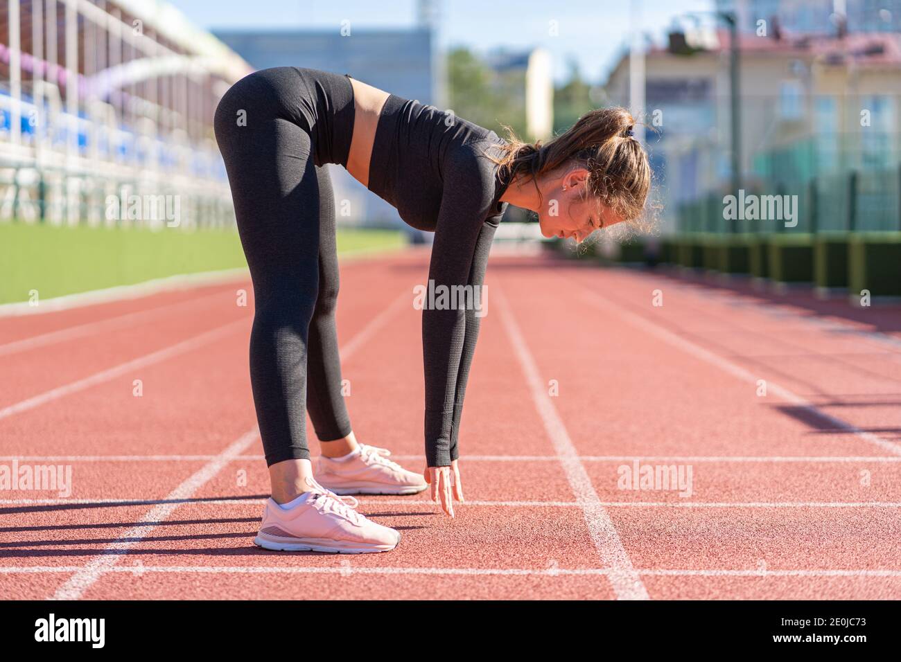 Fit young woman in black sportswear working out on a treadmill rubber ...