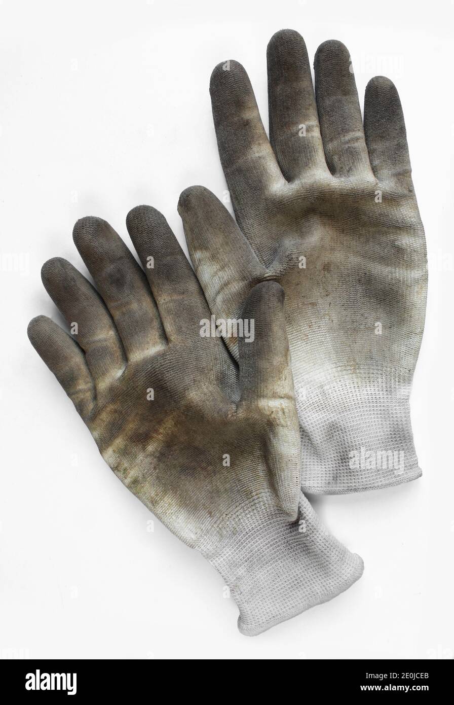 Pair of worn gloves isolated on white background. Dirty used working ...