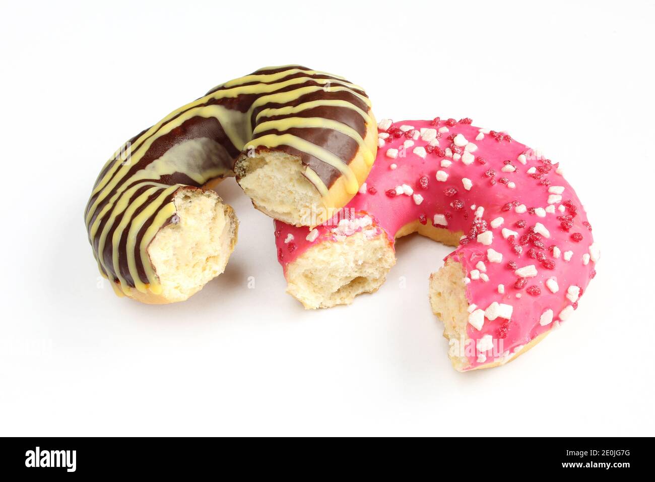 Two bitten donuts with colorful icing isolated on white background ...
