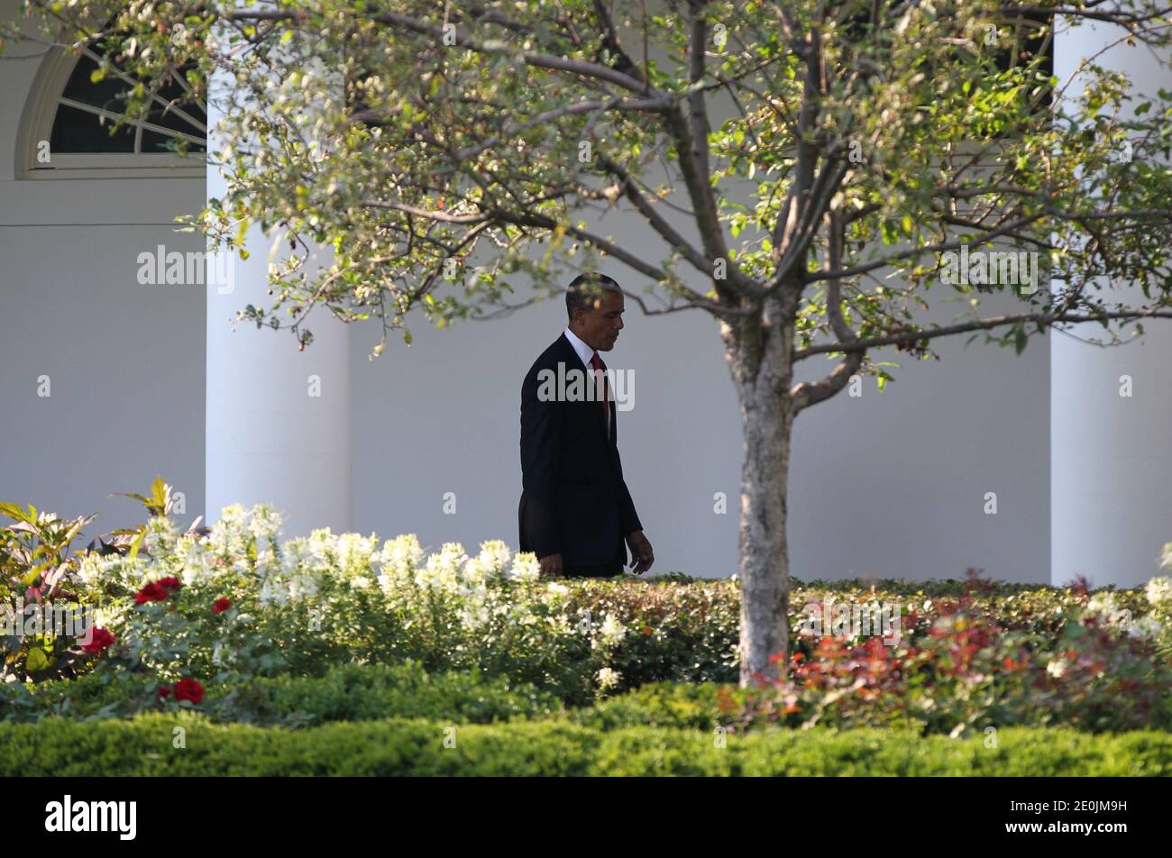 US President Barack Obama walks out of the Oval Office before departing ...