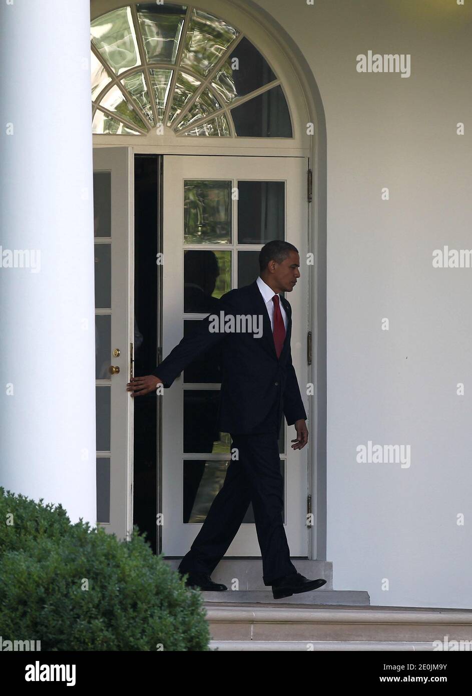 US President Barack Obama walks out of the Oval Office before departing ...
