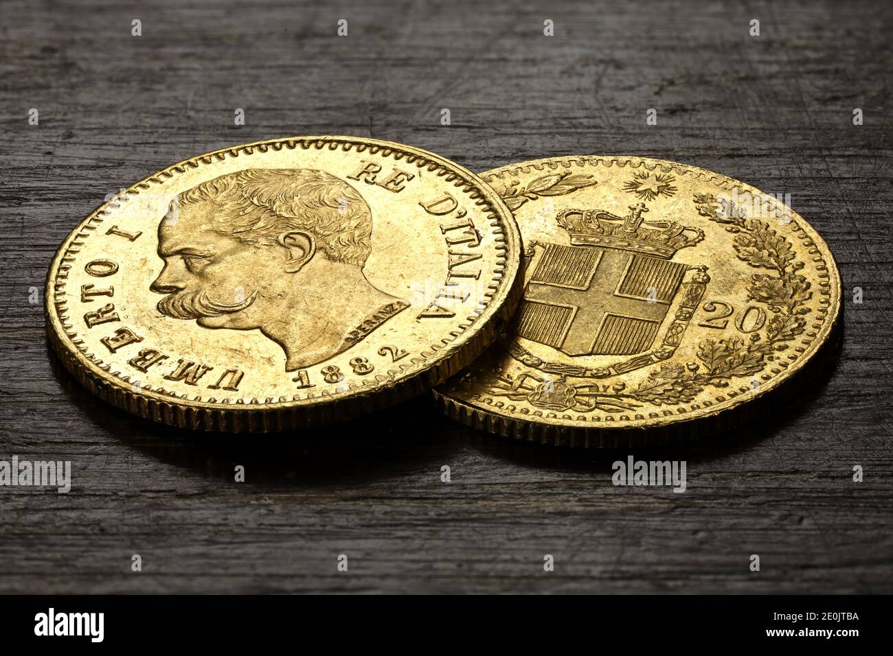 Italian 20 Lira gold coins on rustic wooden background Stock Photo - Alamy
