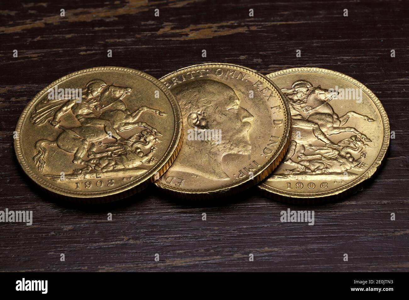 British full Sovereign gold coins (Edward VII) on rustic wooden ...