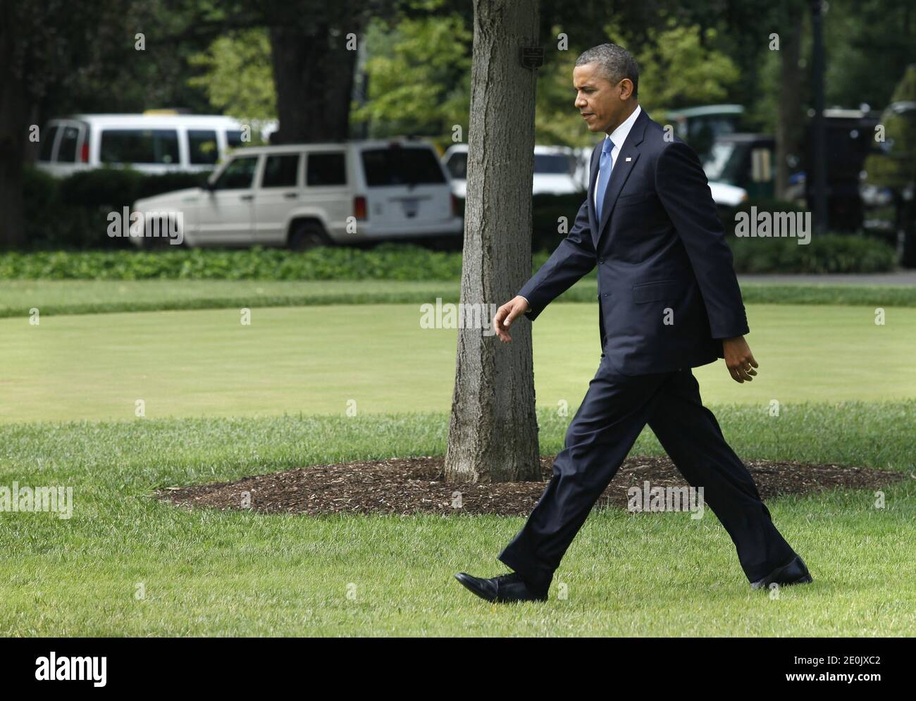 U.S. President Barack Obama walks on the South Lawn as he departs to ...