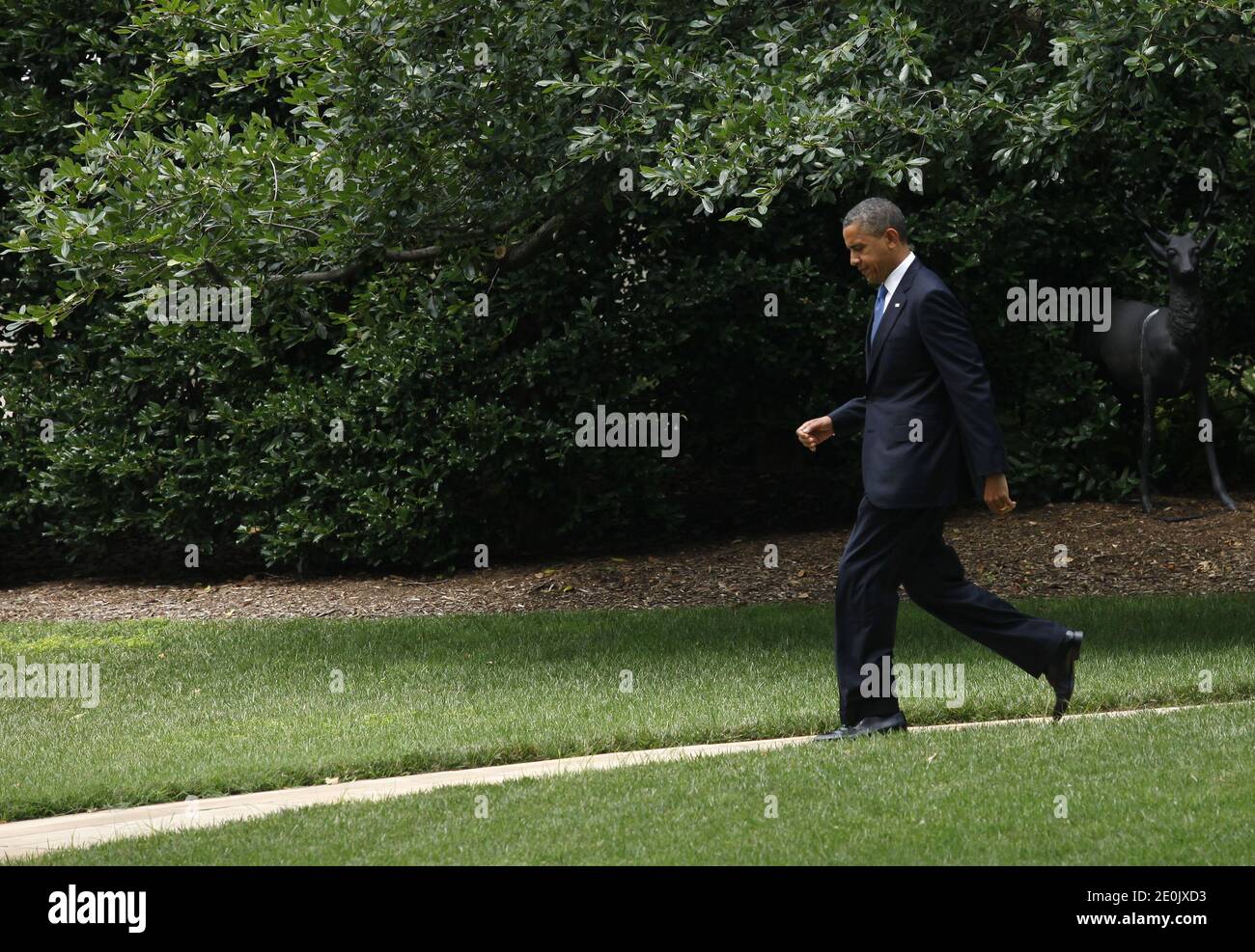 U.S. President Barack Obama walks on the South Lawn as he departs to ...