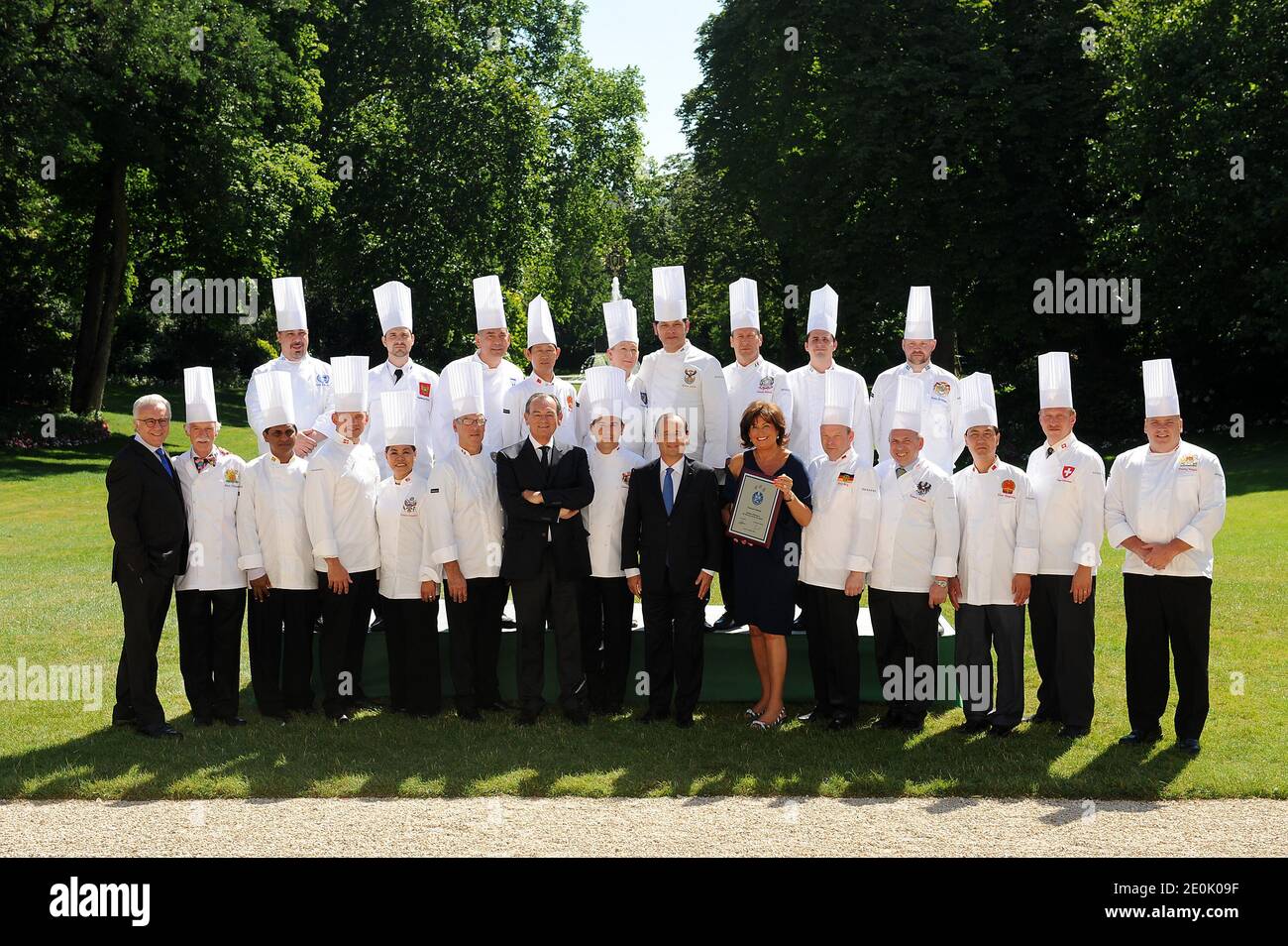 French President Francois Hollande poses with chefs during a reception ...