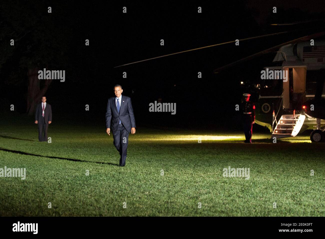 US President Barack Obama walks on the South Lawn of the White House as ...