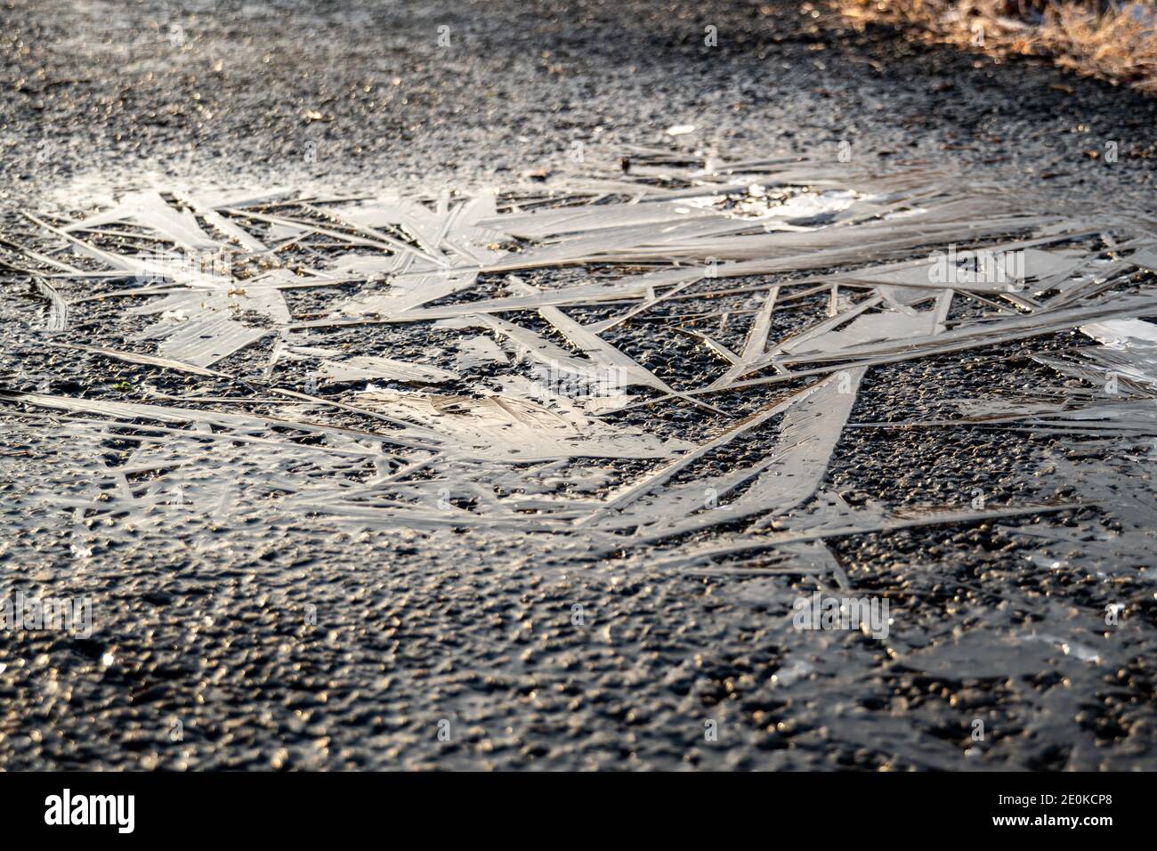 Paved path with black ice and ice crystal formations Stock Photo - Alamy